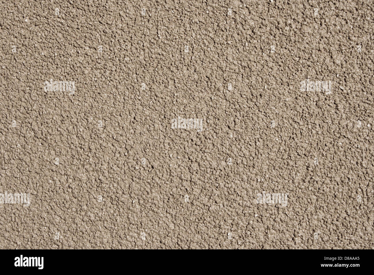 A close-up of beige stucco texture, highlighting its smooth, textured ...