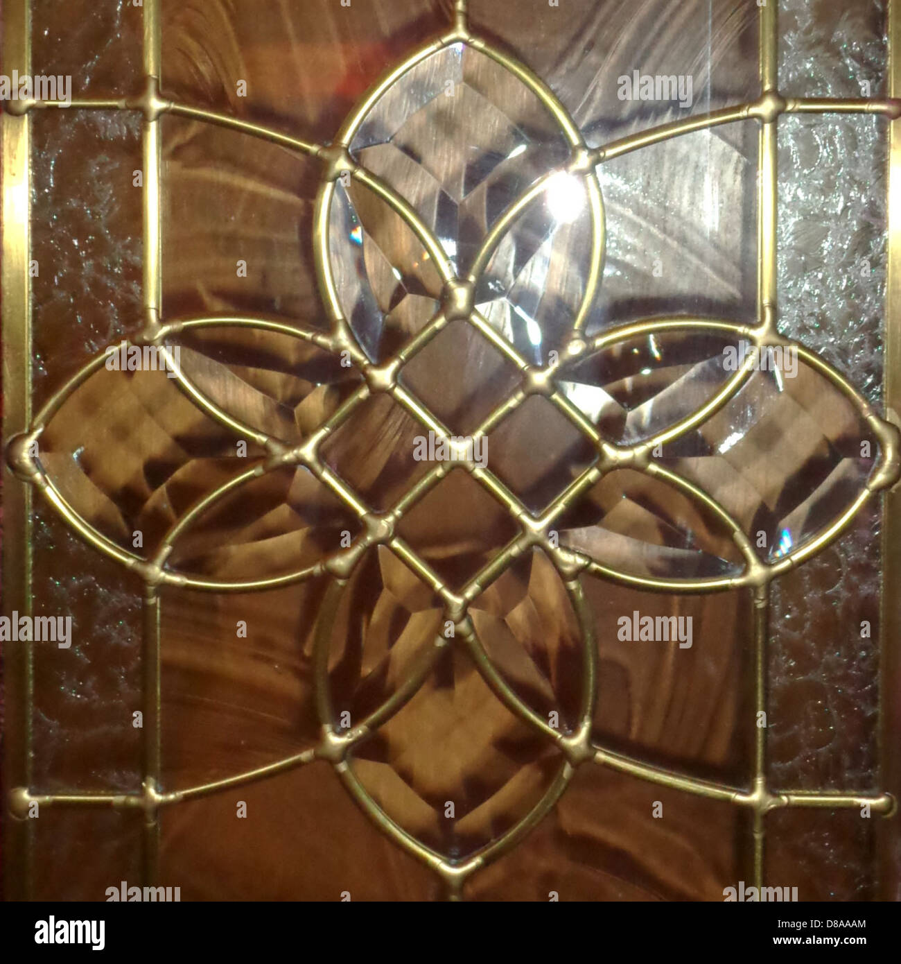 A stained glass panel with beveled edges features a decorative star ...