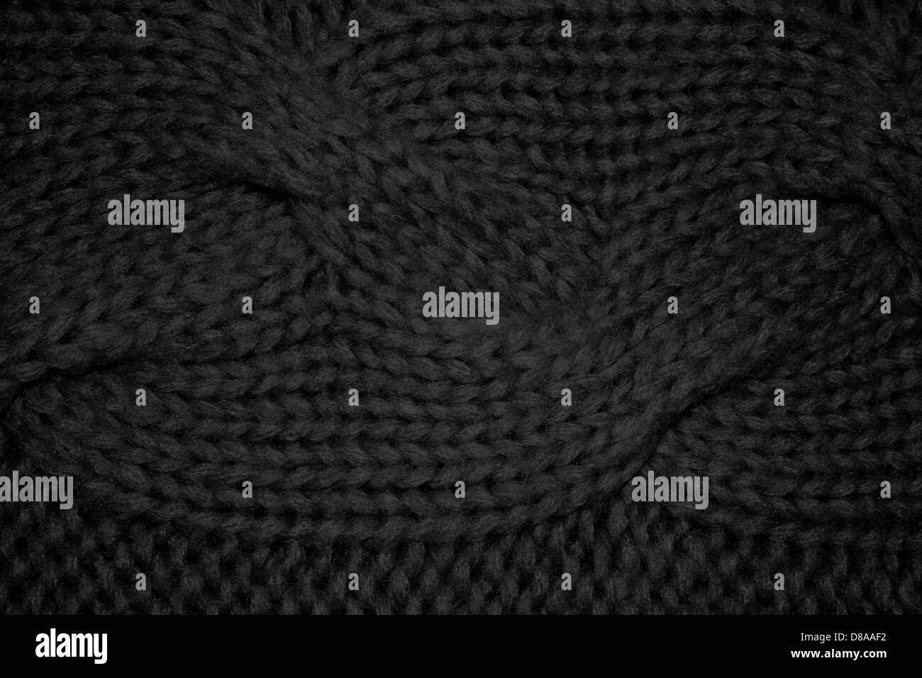 A close-up of a black cable knit pattern, showcasing the intricate ...