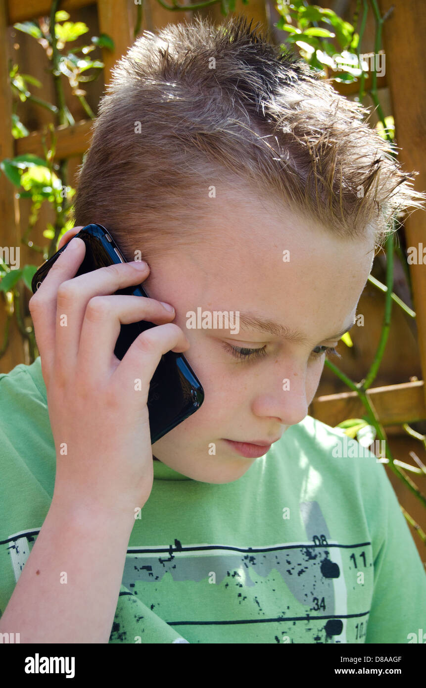 Young Boy talking on a mobile phone Stock Photo - Alamy