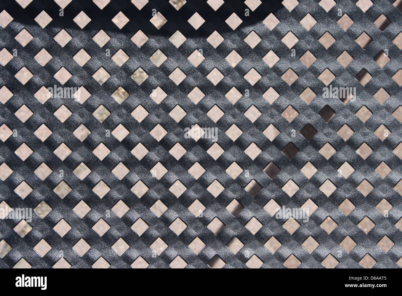 A close-up image showing a black metal cross grid, which serves as a ...