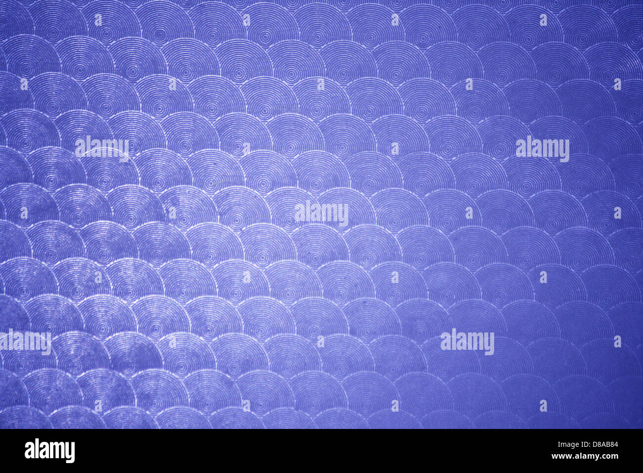 A close-up of a blue circle patterned plastic texture. The smooth ...