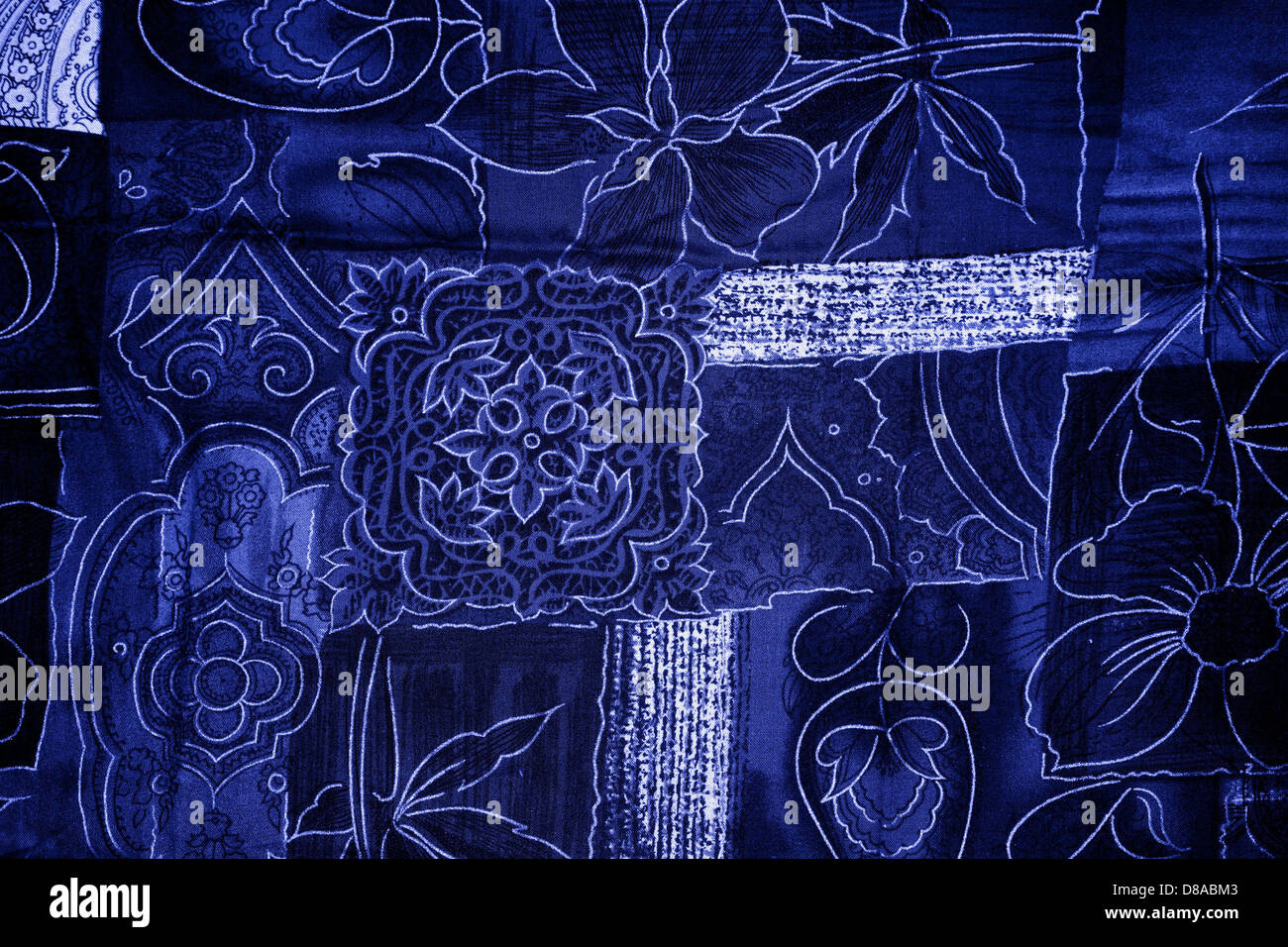 A blue patchwork fabric texture is displayed, featuring various shades ...