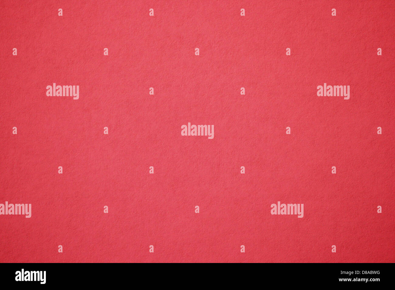 A close-up image of bright red paper showcasing its smooth texture ...