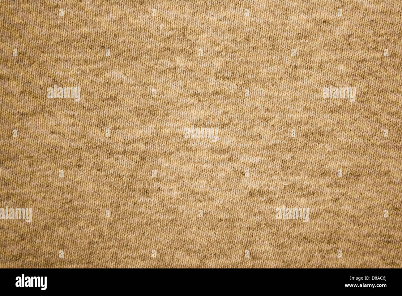 The texture of a brown heather knit T-shirt fabric is displayed ...