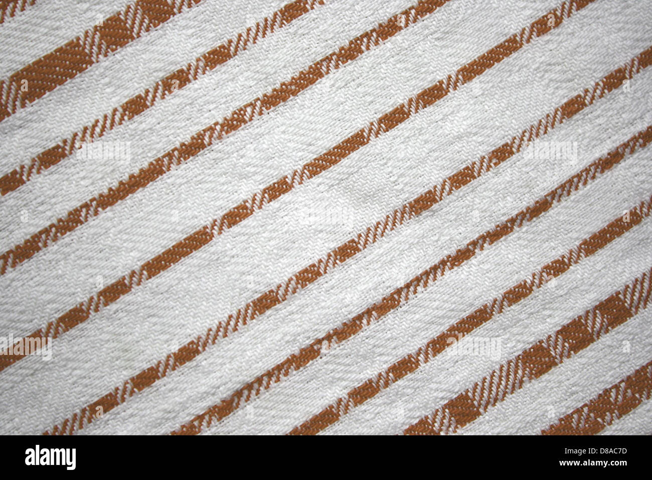 A close-up of fabric featuring a brown and white diagonal stripe ...