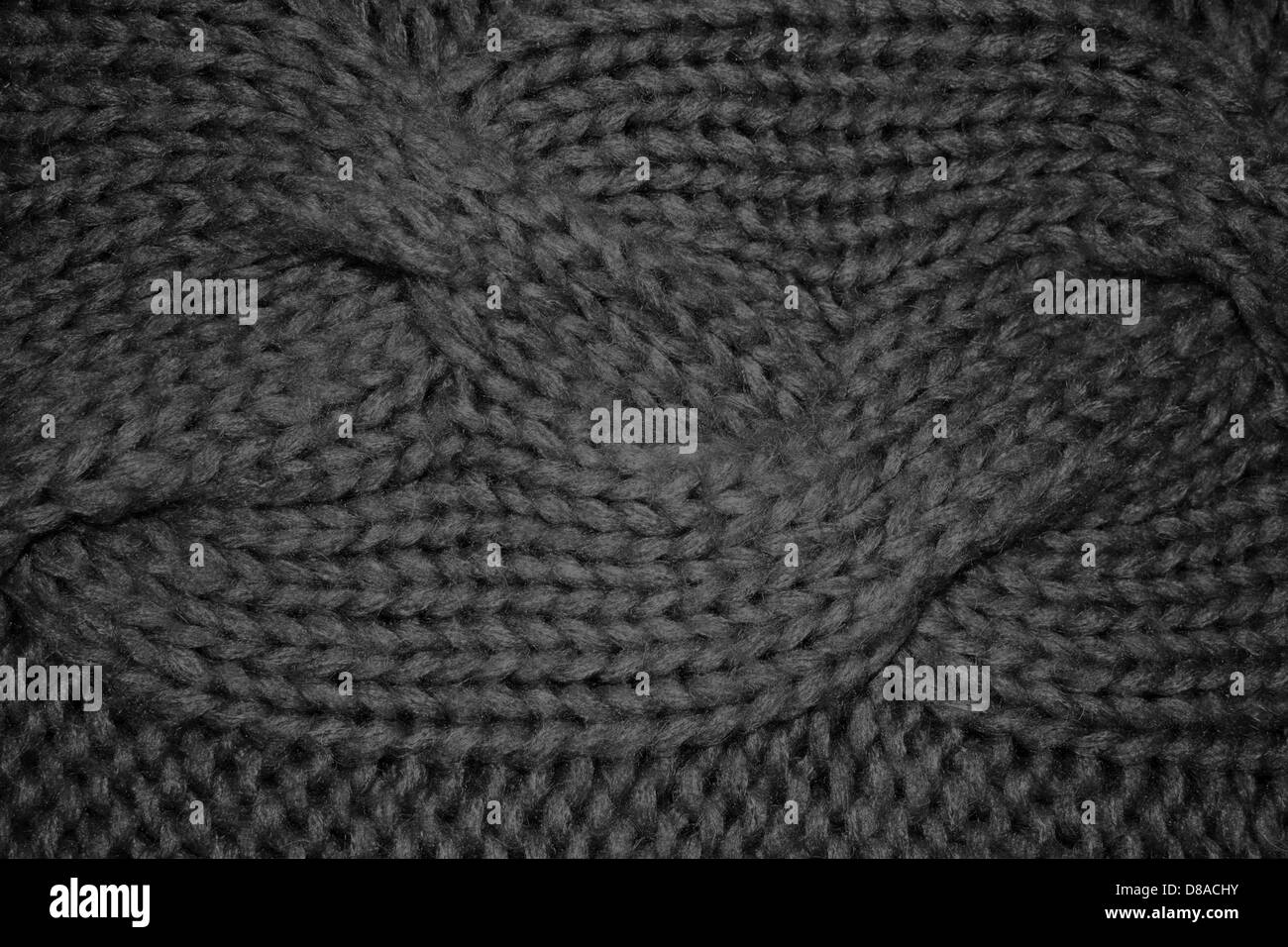 A close-up of a charcoal gray cable knit pattern, showcasing the ...