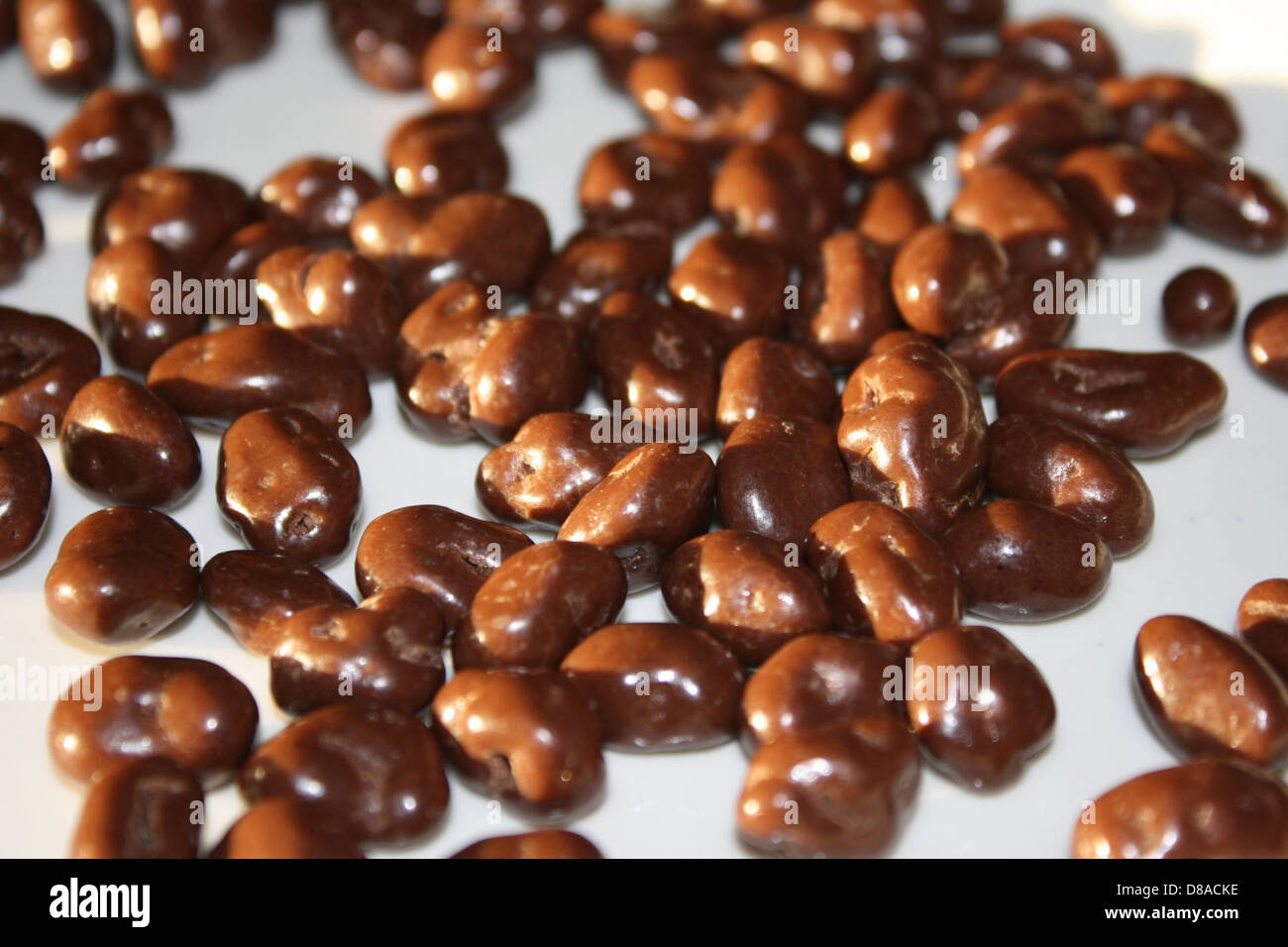 This image shows chocolate-covered raisins, a sweet treat that combines ...