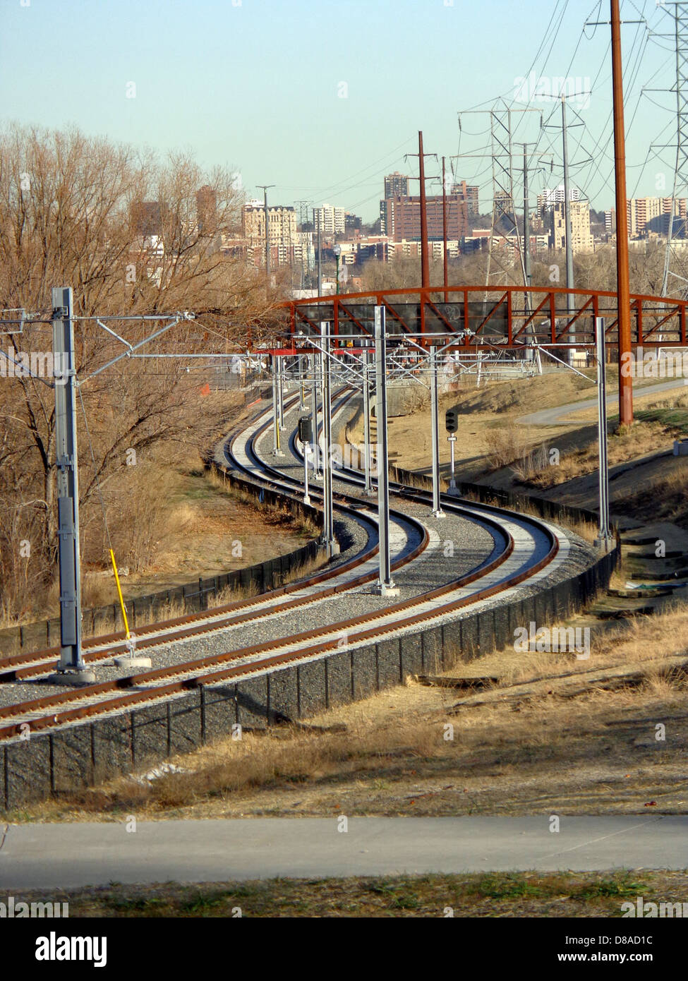 Curving light rail train tracks extend into the distance, forming a ...