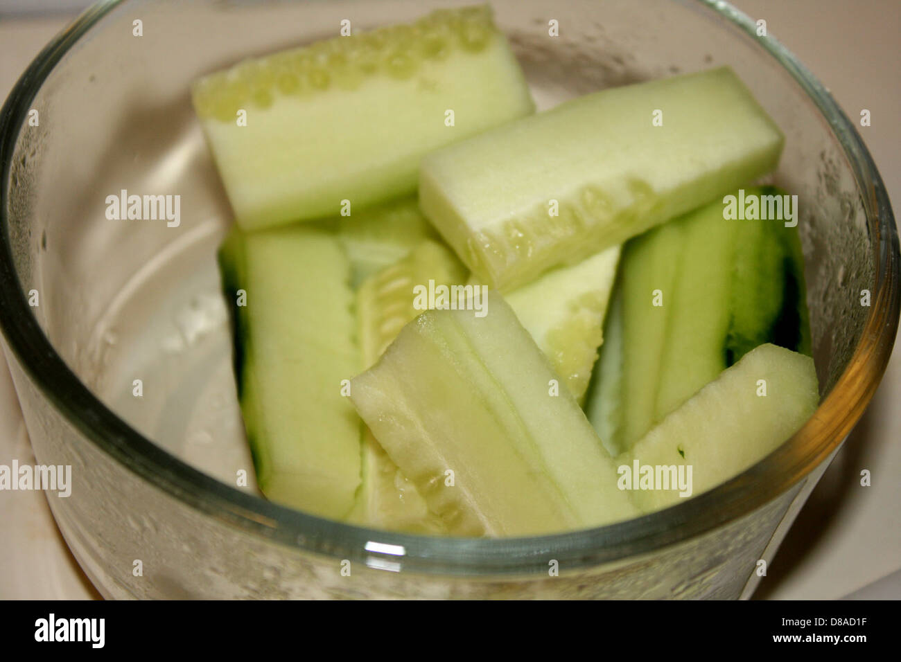 A glass bowl filled with freshly cut cucumber pieces. The image ...