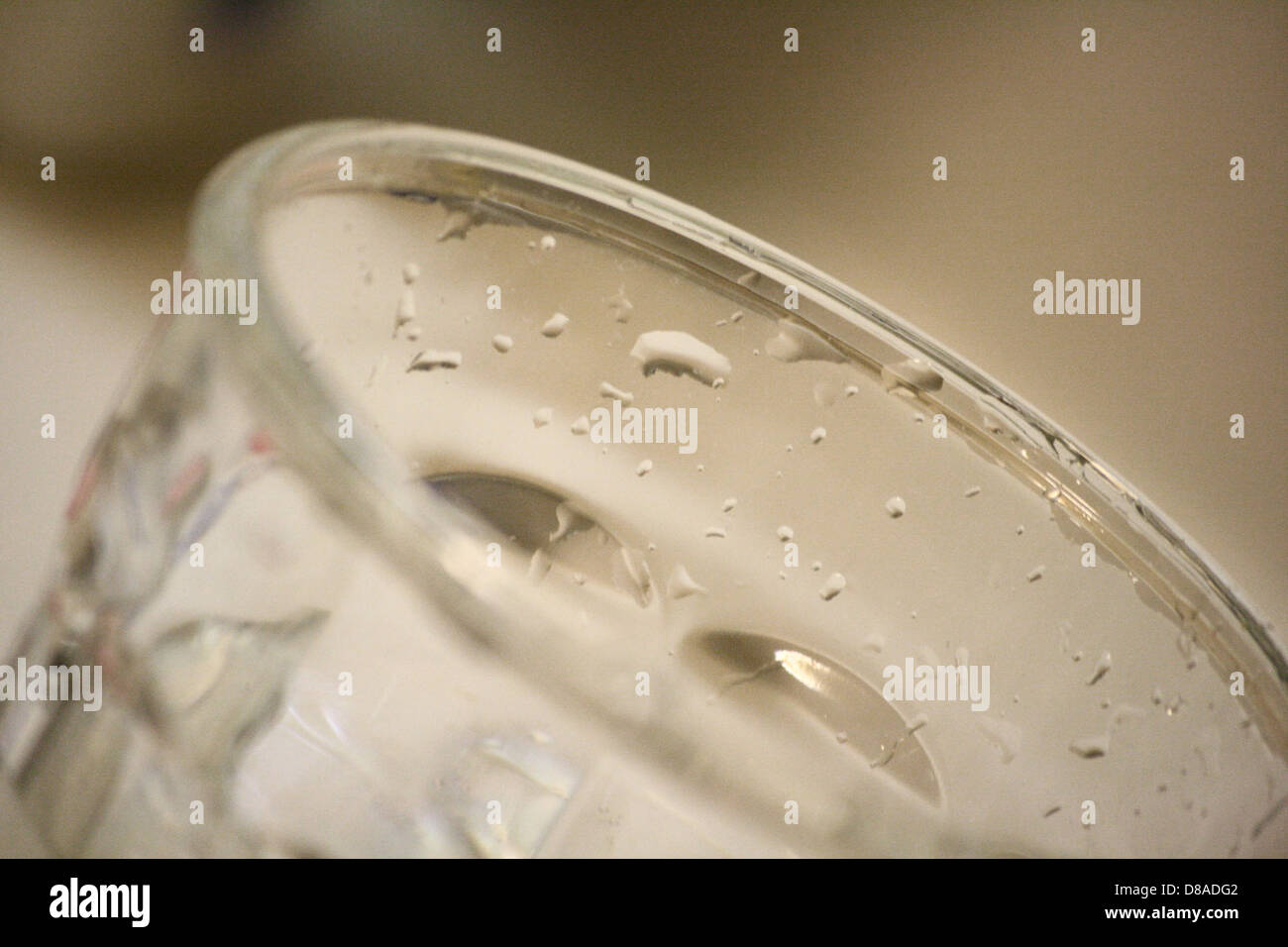 A close-up image showing water droplets on the rim of a drinking glass ...