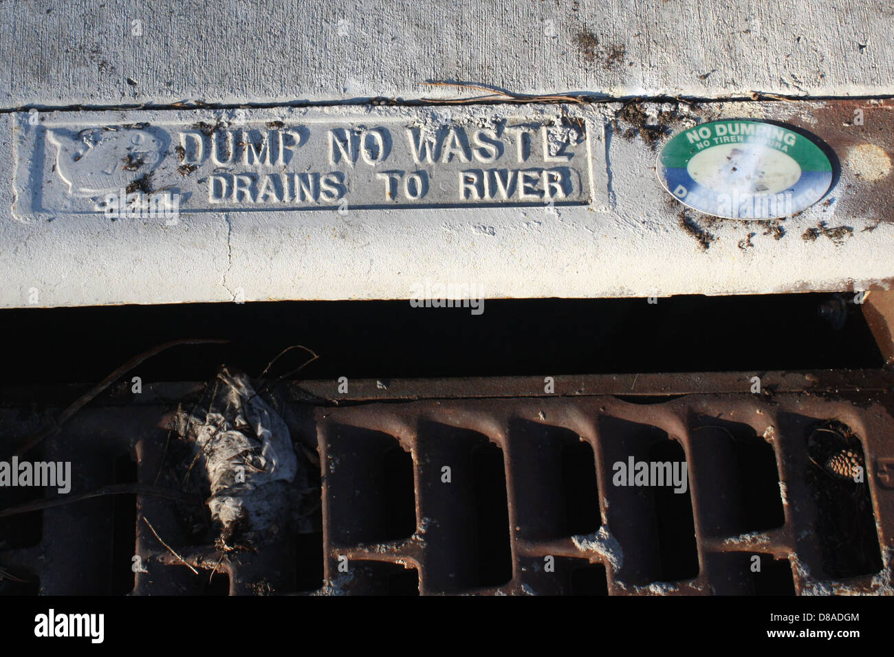 This image features a storm drain with a 'Dump No Waste, Drains to ...