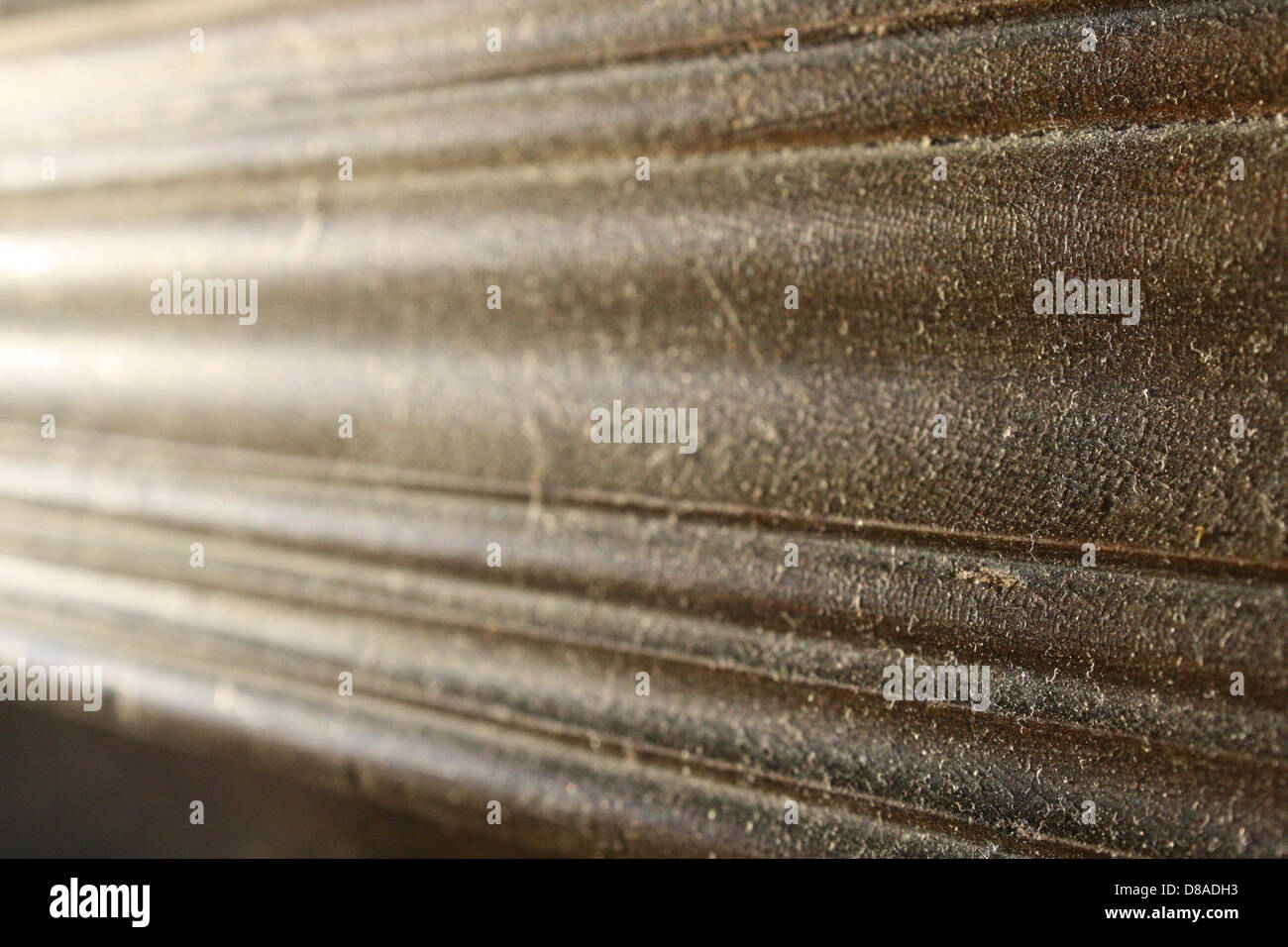 The photo shows a layer of dust accumulated on wood trim, highlighting ...