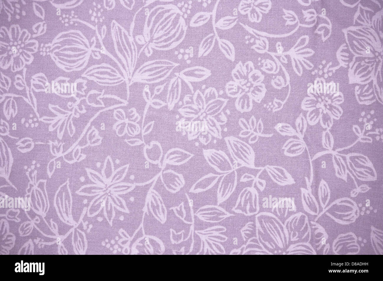 A close-up of dusty purple fabric featuring a floral pattern. The ...