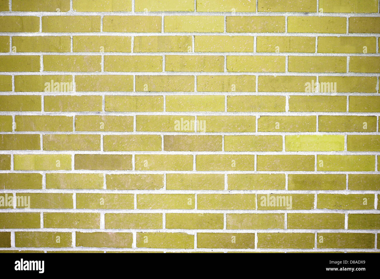 This image features a textured gold brick wall, where the golden color ...