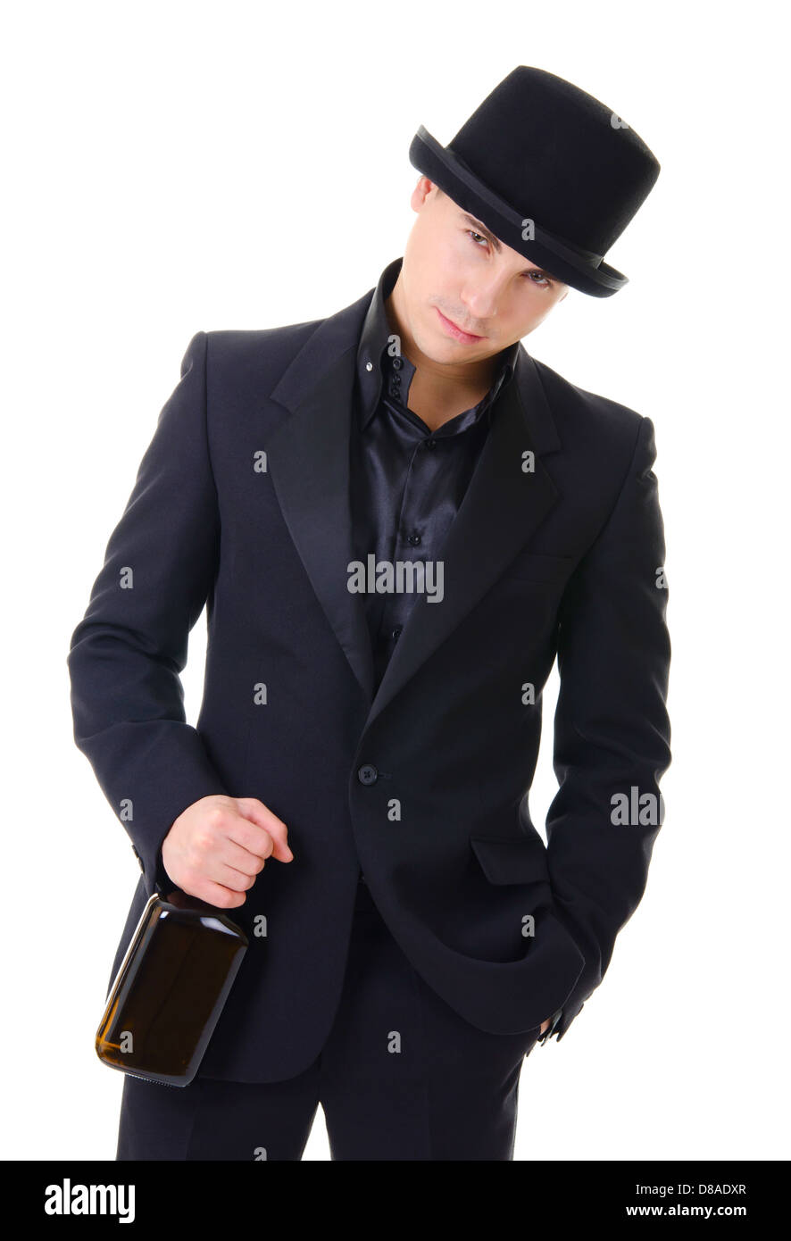 Serious man with whisky bottle in black suit and hat in austere style ...