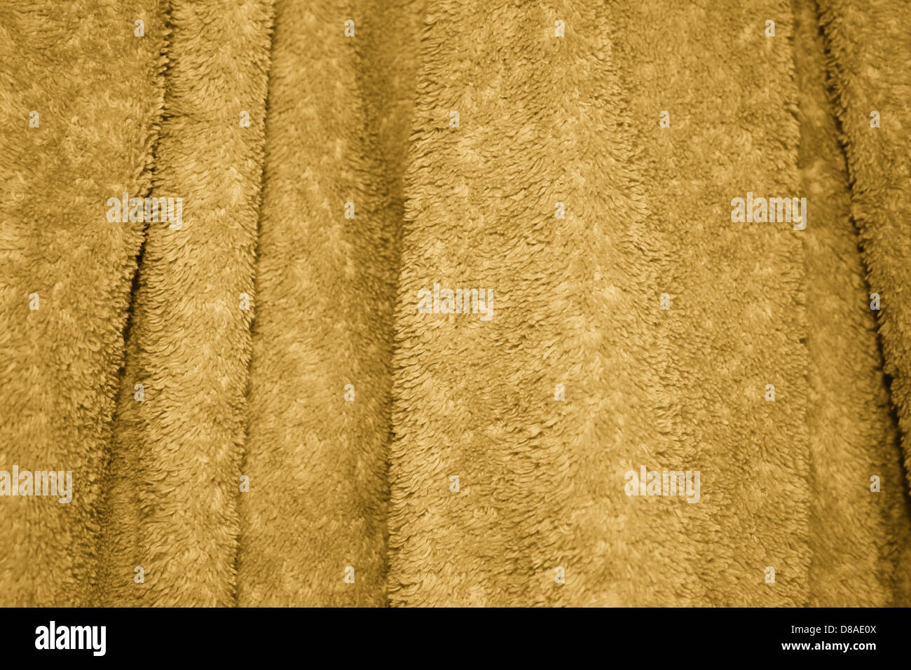A close-up of a gold terry cloth bath towel, showcasing its plush ...