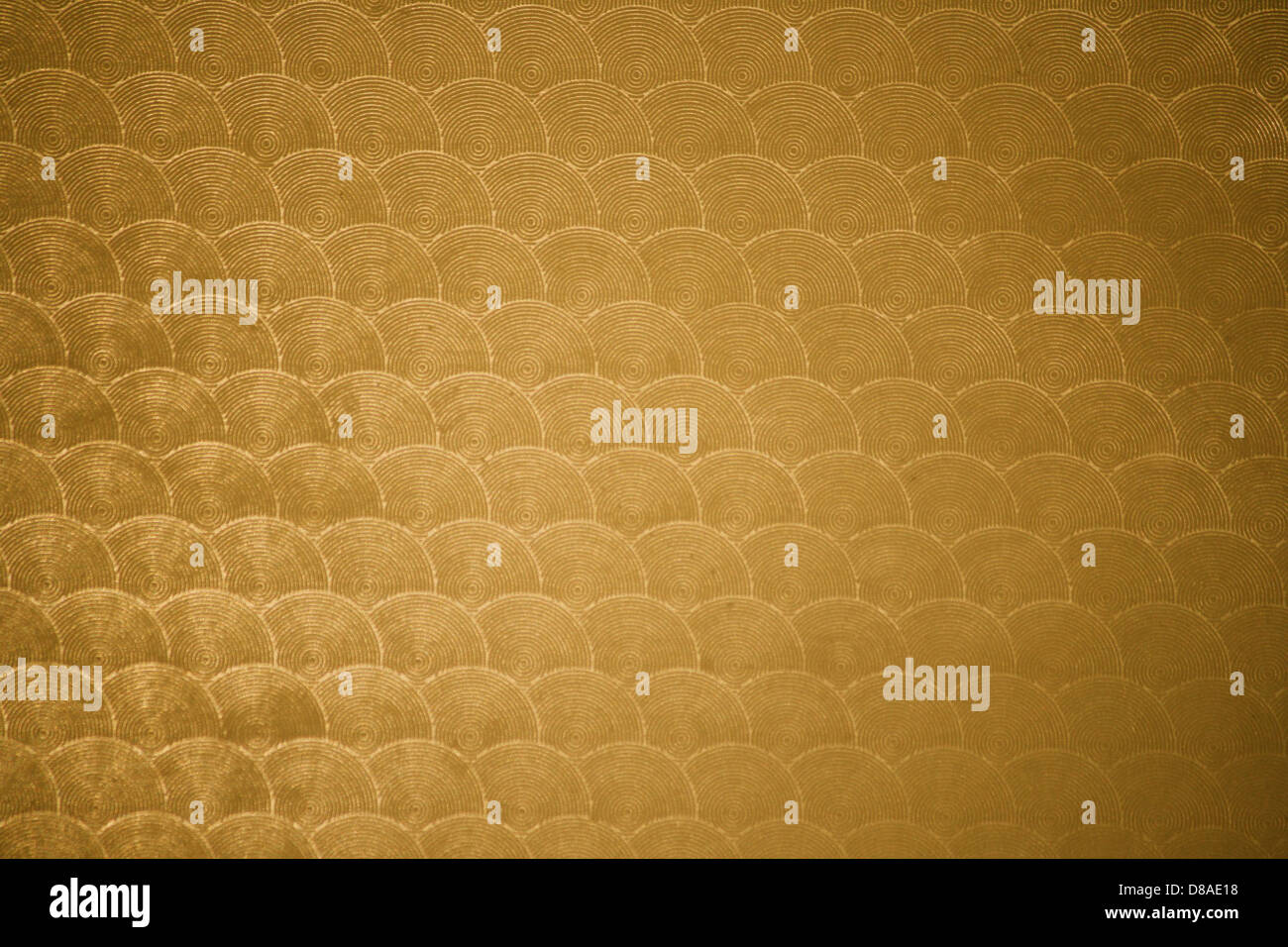 A close-up of golden circle patterned plastic texture. The plastic ...
