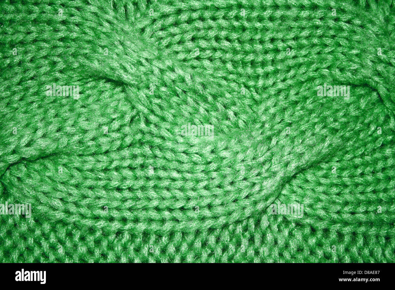 A close-up view of a green cable knit pattern, highlighting the ...