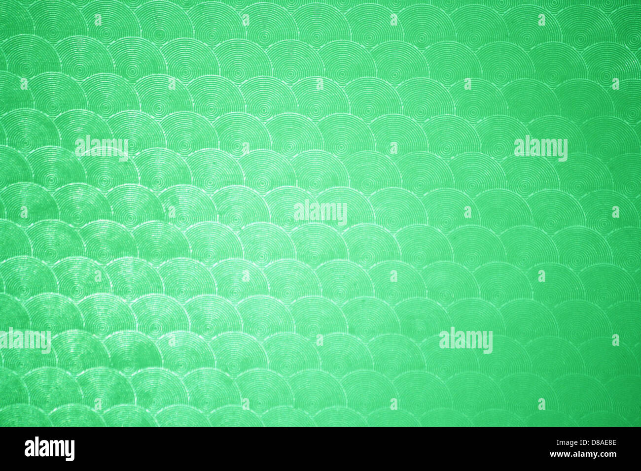 A plastic surface featuring a repeating pattern of green circles ...