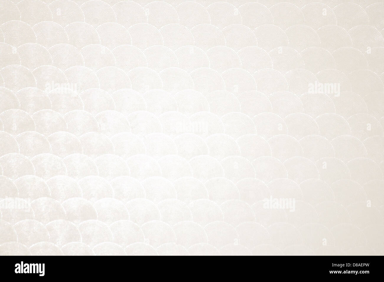 A close-up of an ivory off-white plastic surface, featuring a circular ...