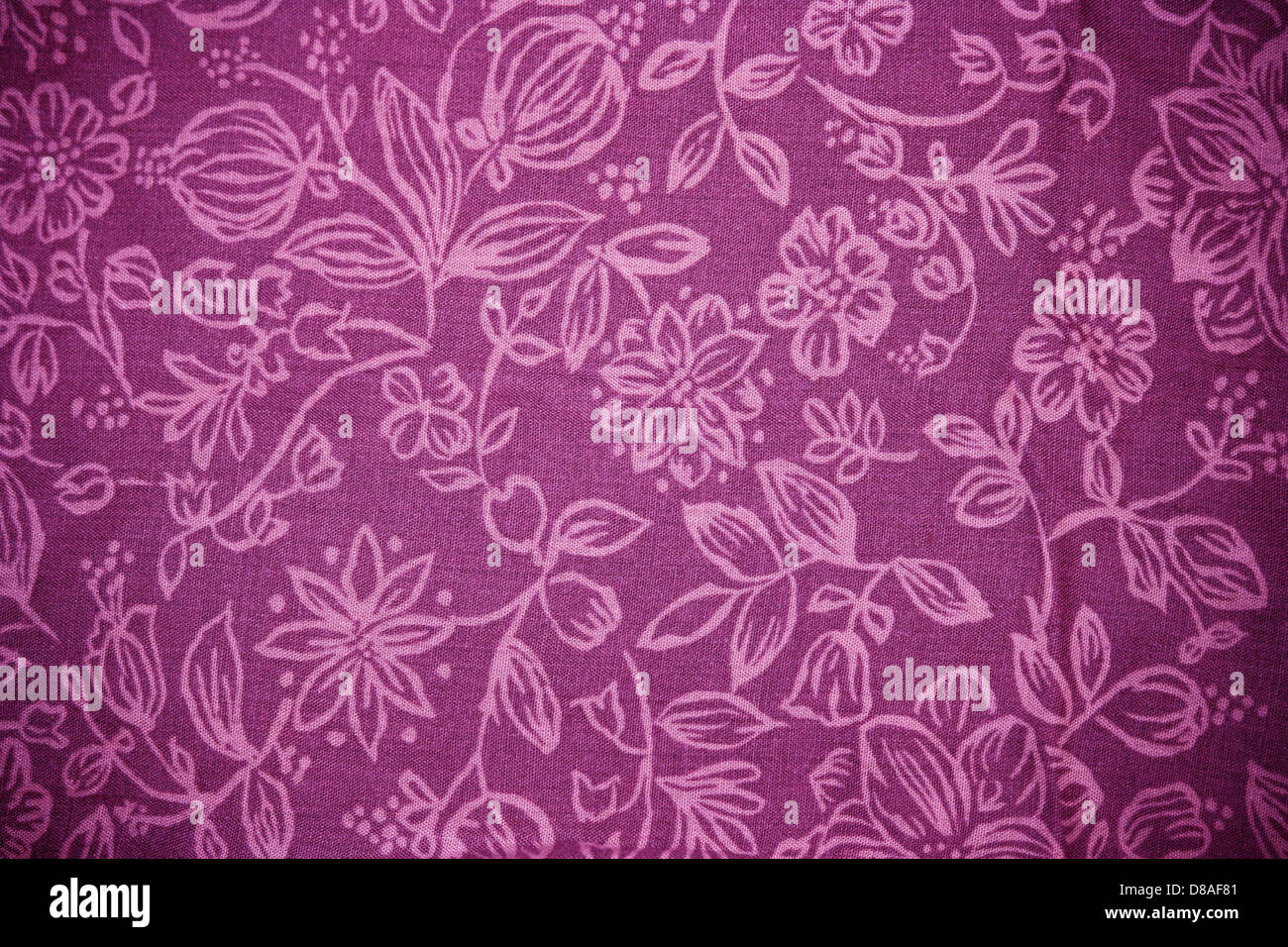 A close-up of magenta fabric featuring a floral pattern. The texture ...