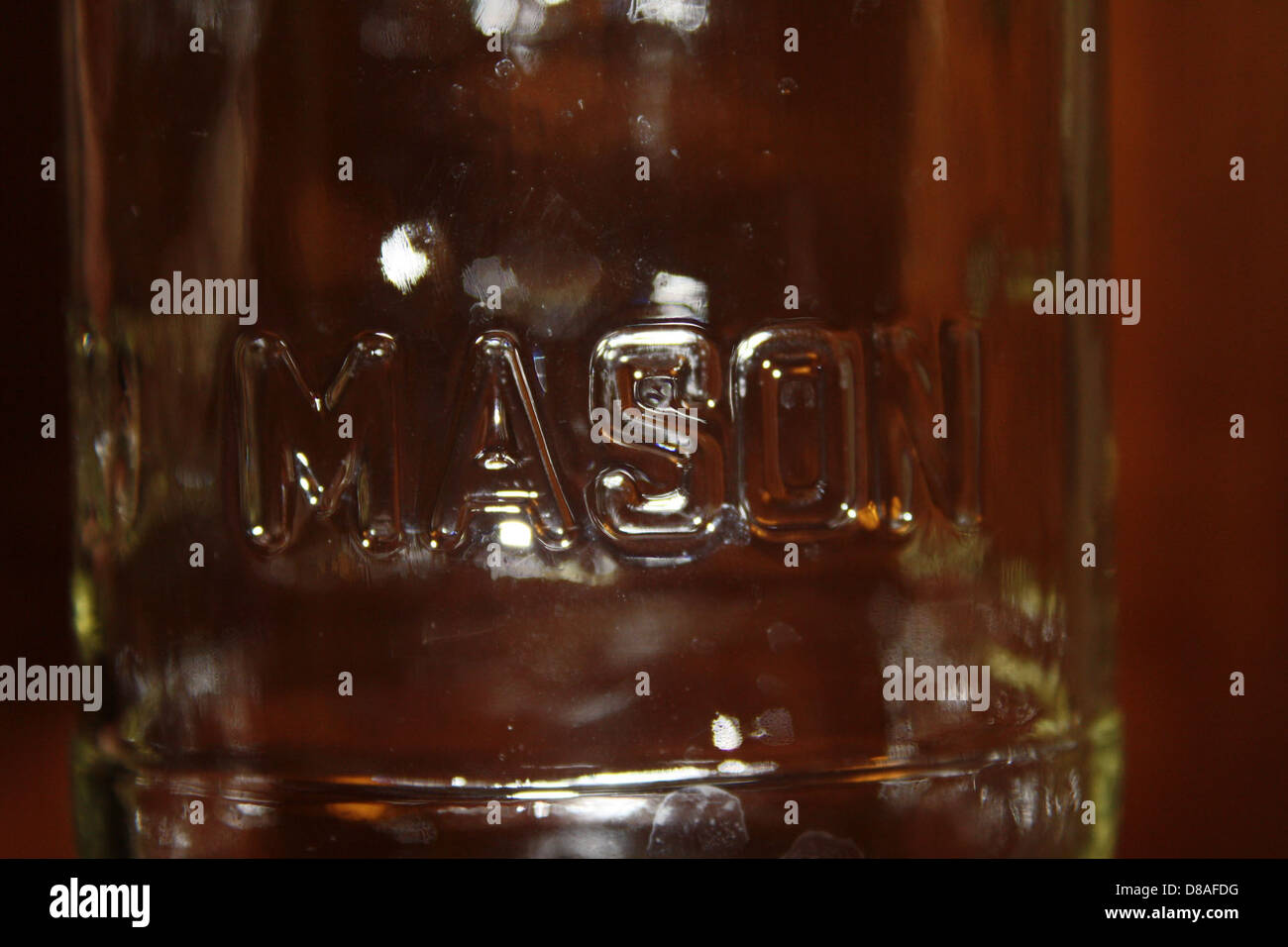 A close-up of a classic mason jar, showcasing its smooth glass surface ...