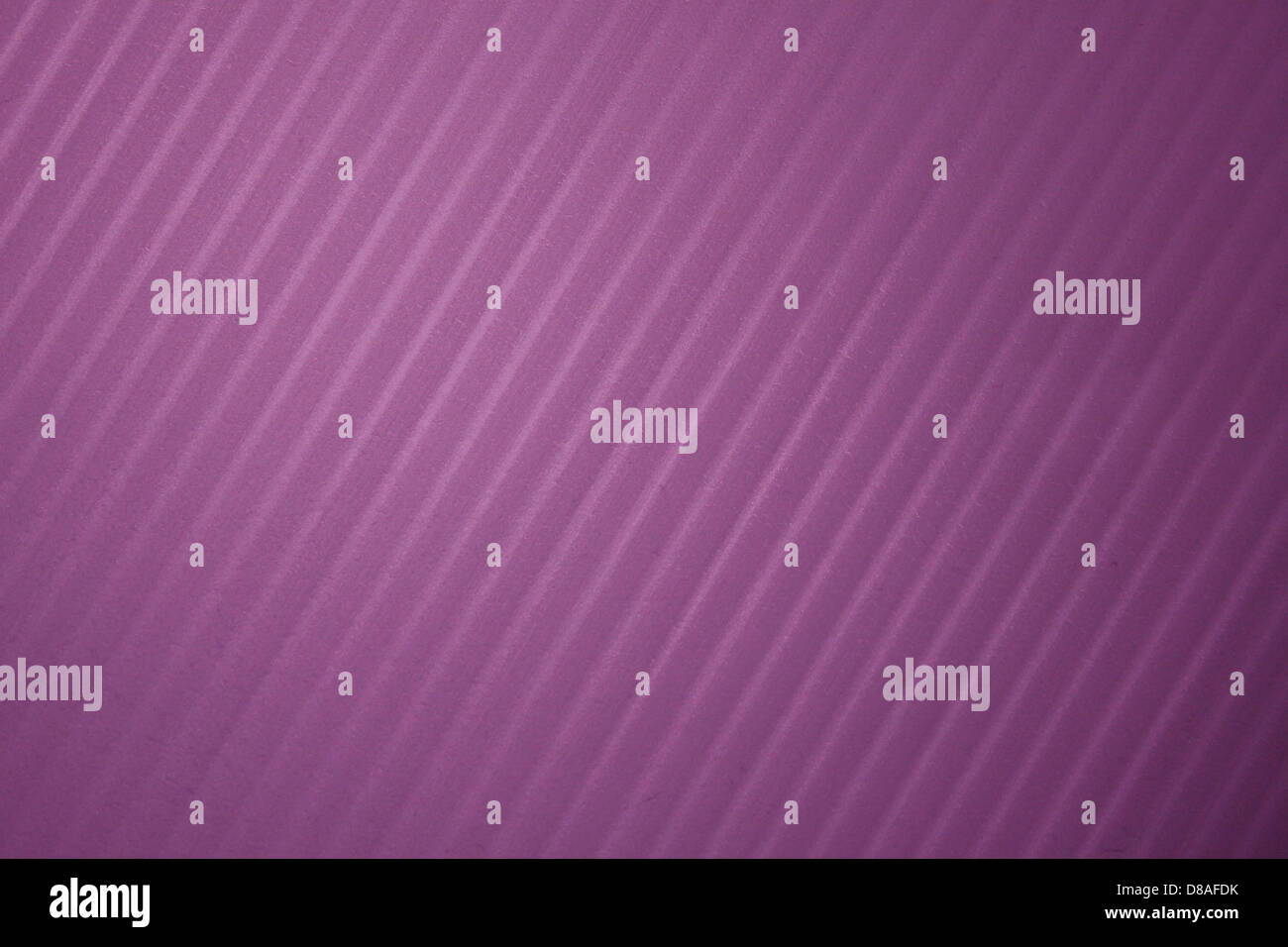 A close-up of mauve-colored, diagonally striped plastic texture. The ...