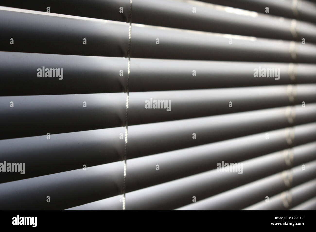 Close-up of a mini blind window shade showing its smooth, layered ...