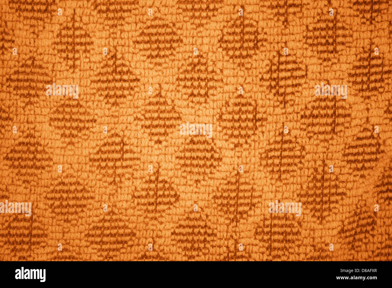 An orange dish towel with a diamond pattern is seen in close-up. The ...