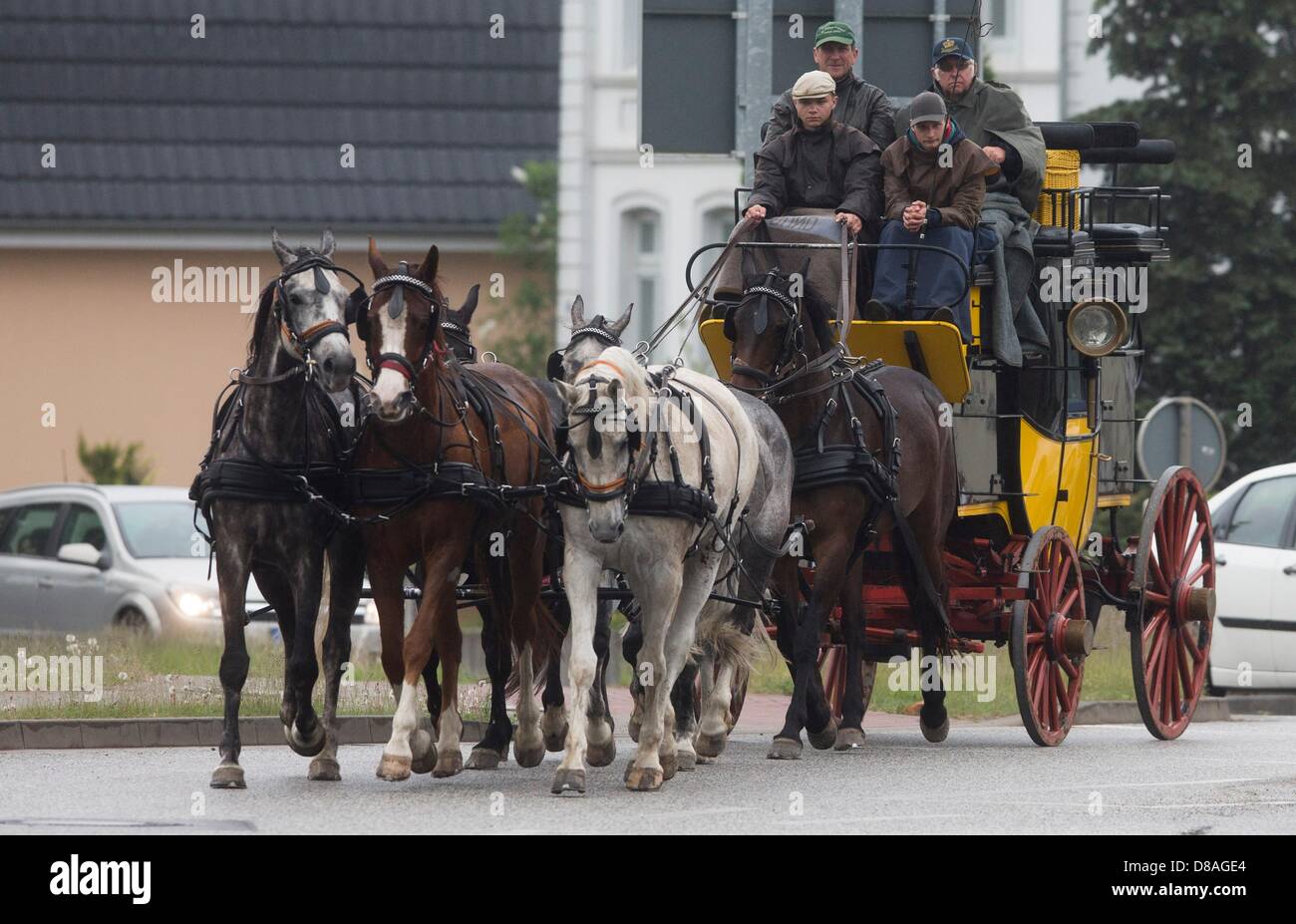 A seven horse-drawn stagecoach goes along a road between Parchim and ...