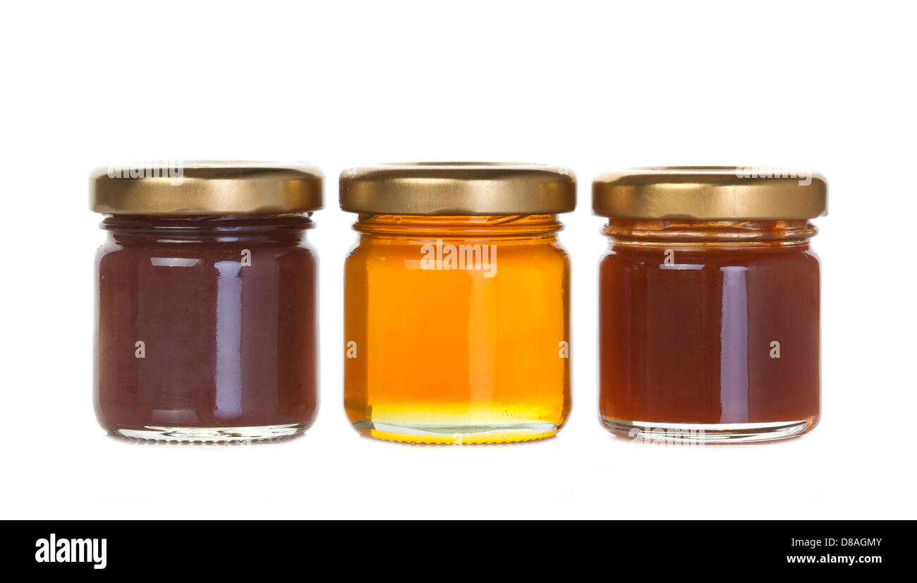 Three jar of jam and honey on white background Stock Photo - Alamy