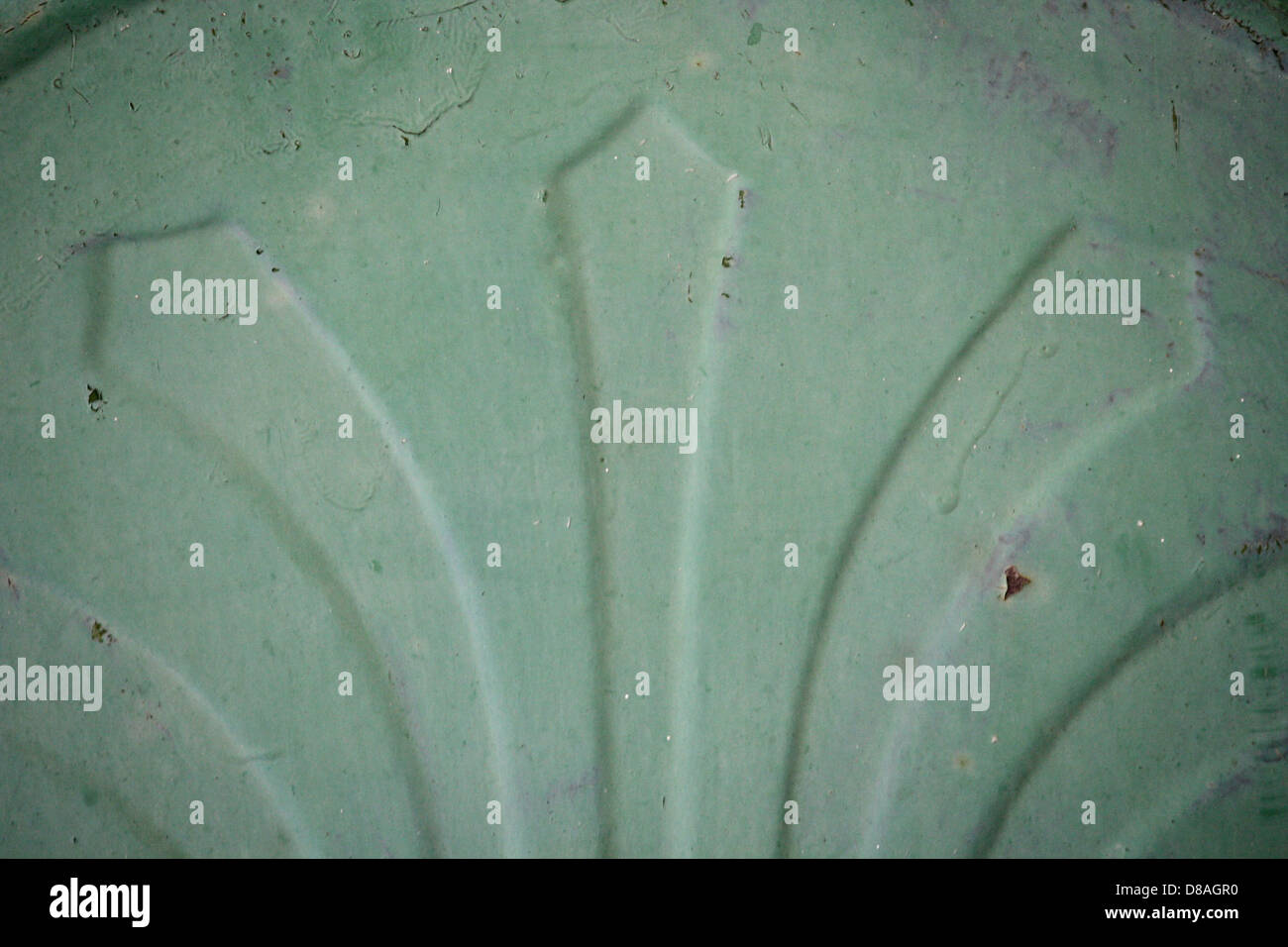 raised arrow design on grungy old green metal texture Stock Photo - Alamy