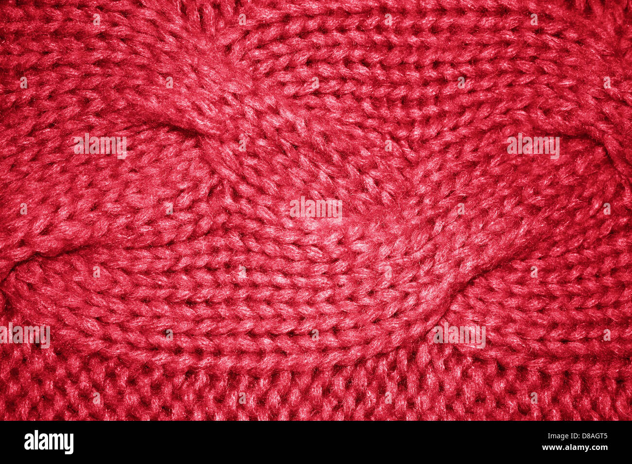 A close-up of a red cable knit pattern, showcasing the intricate ...