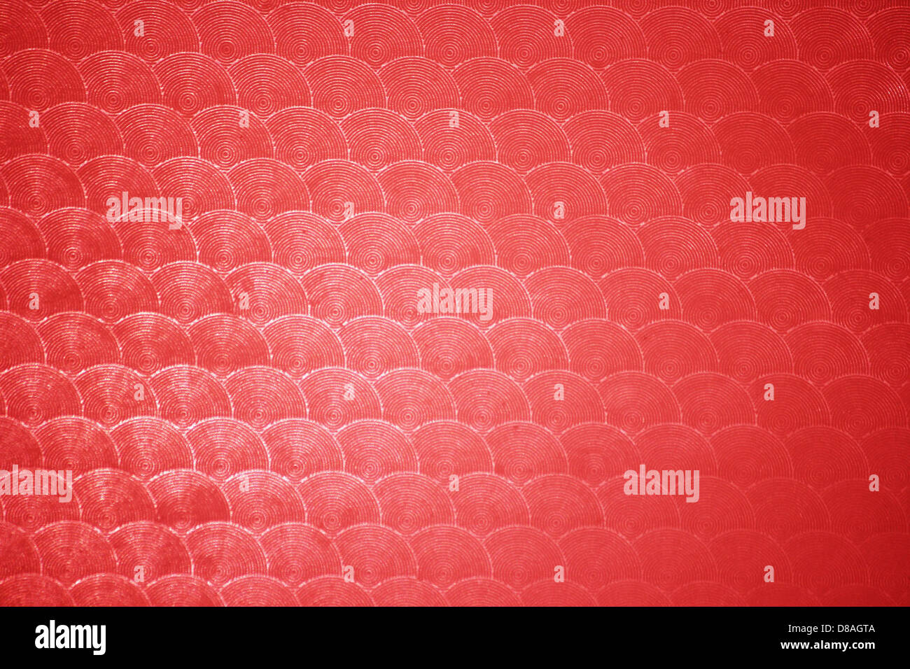 This image shows a close-up of plastic material featuring a red circle ...
