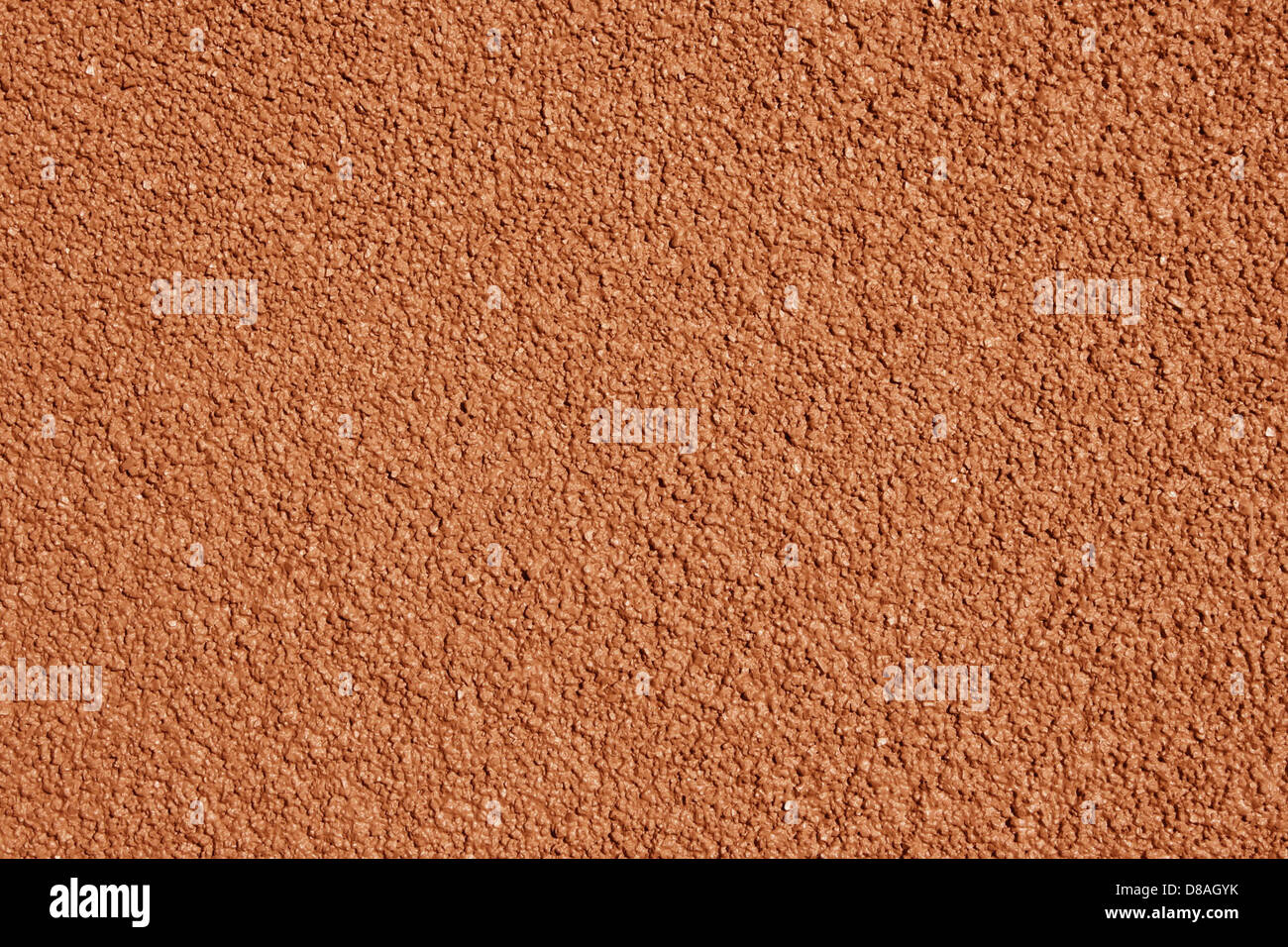 A close-up of red stucco texture, highlighting the rough and textured ...