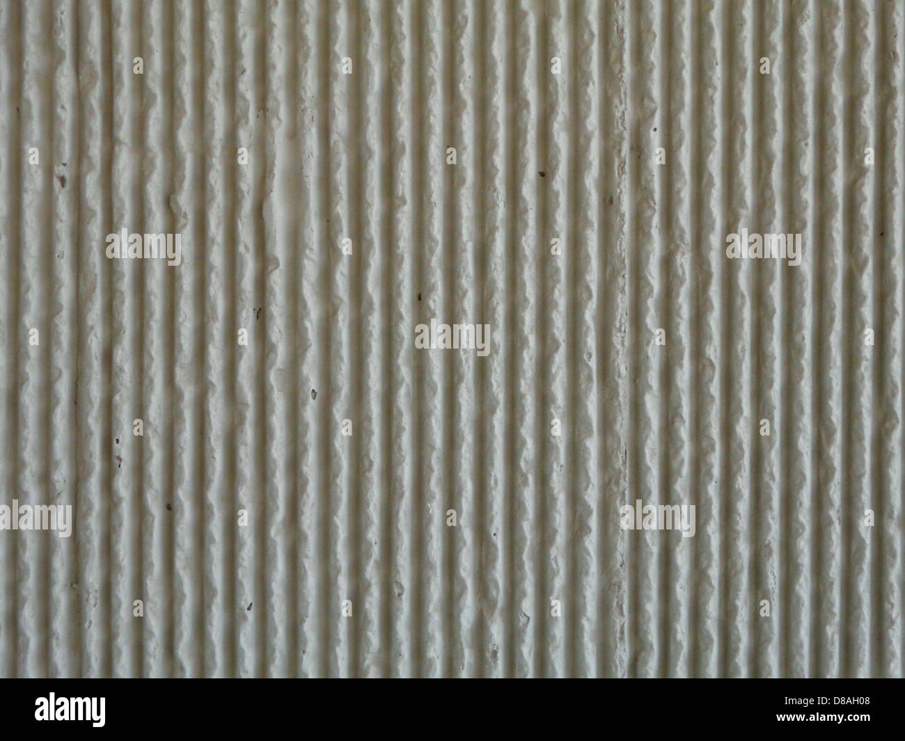 A close-up image of ribbed concrete, showing its textured surface. The ...