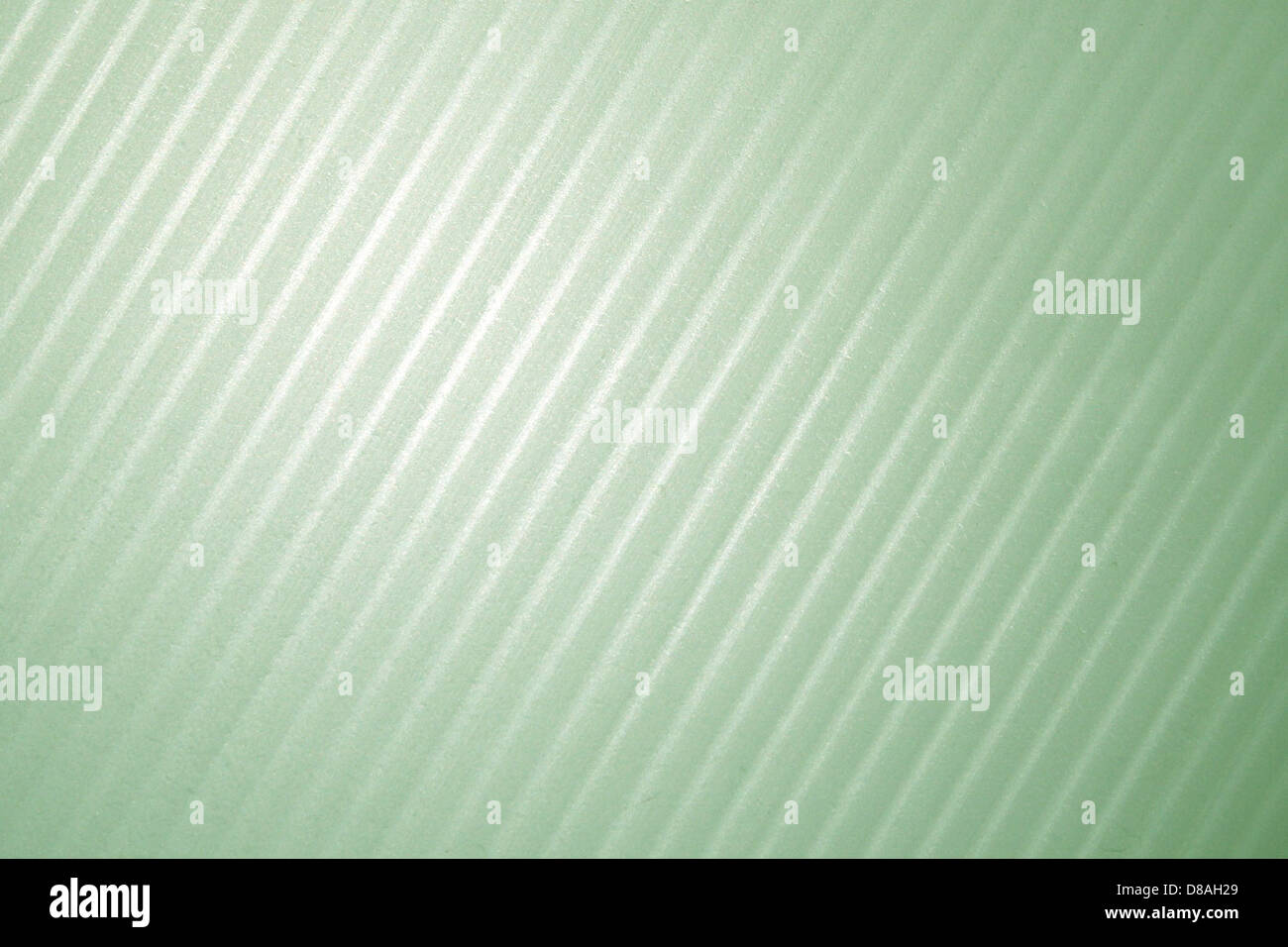 A close-up view of a sage green plastic texture, featuring diagonal ...