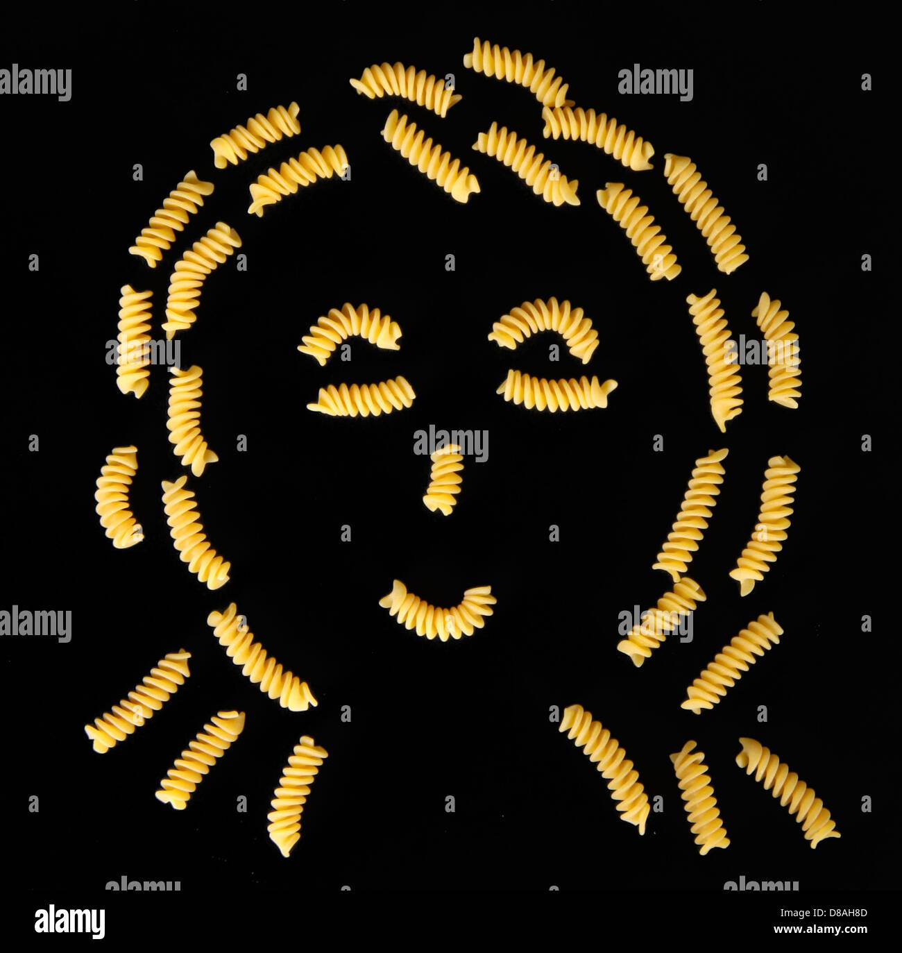 Face of pasta fusilli on black background Stock Photo - Alamy