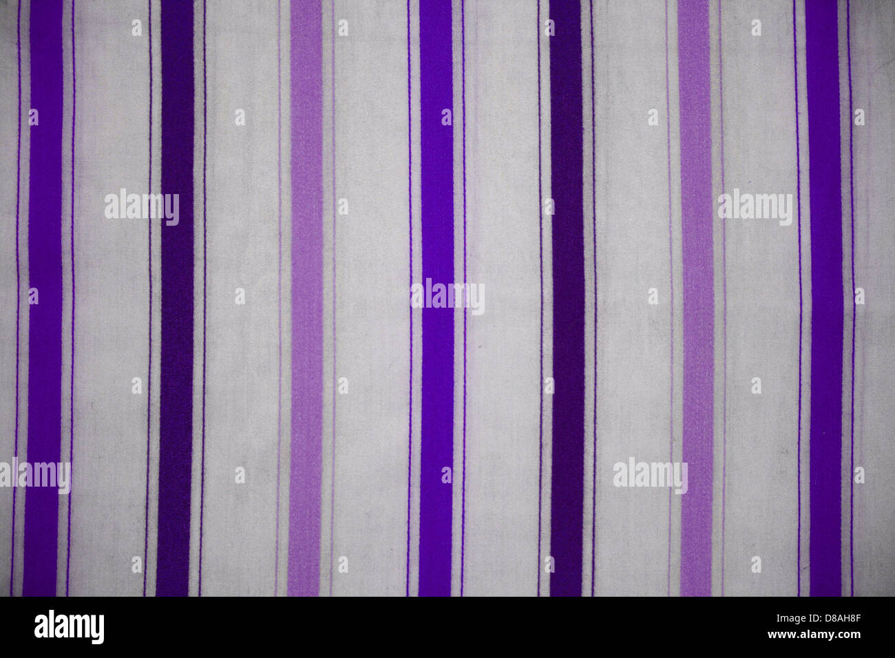 A close-up image of striped fabric with alternating purple and white ...
