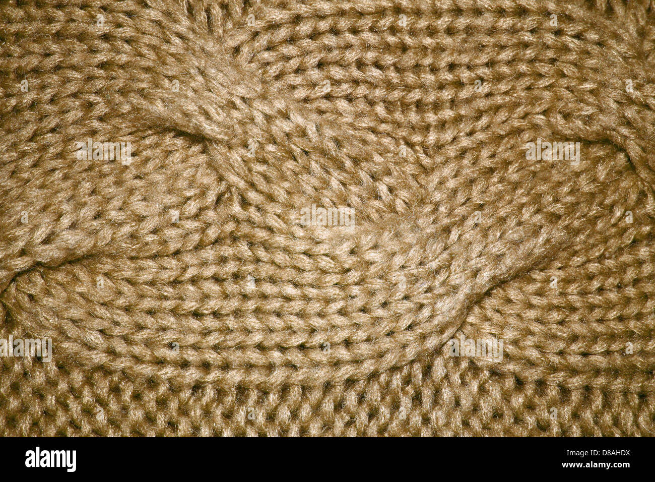 A close-up image of a tan cable knit pattern, showcasing the intricate ...