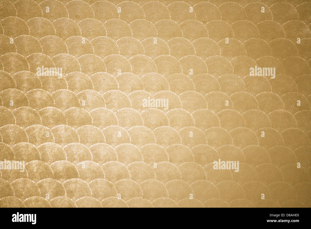 A close-up view of tan plastic with a circle pattern texture. This ...