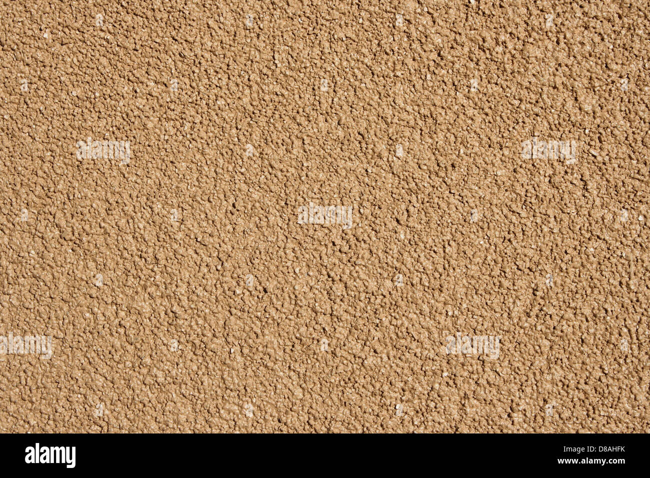 A close-up of tan stucco texture, highlighting the smooth yet rugged ...