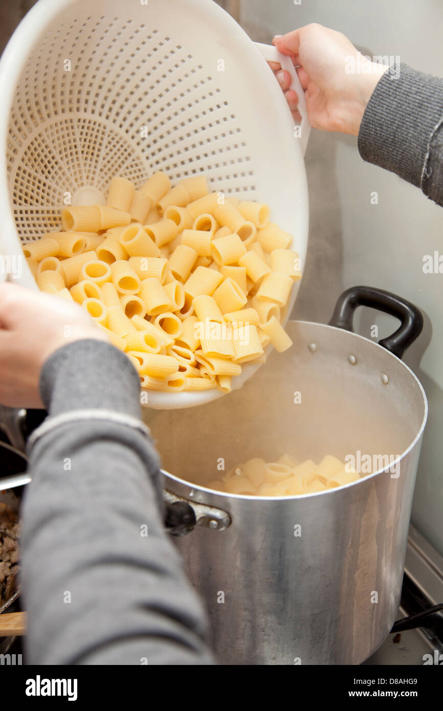 Cooking pasta with a colander Stock Photo - Alamy