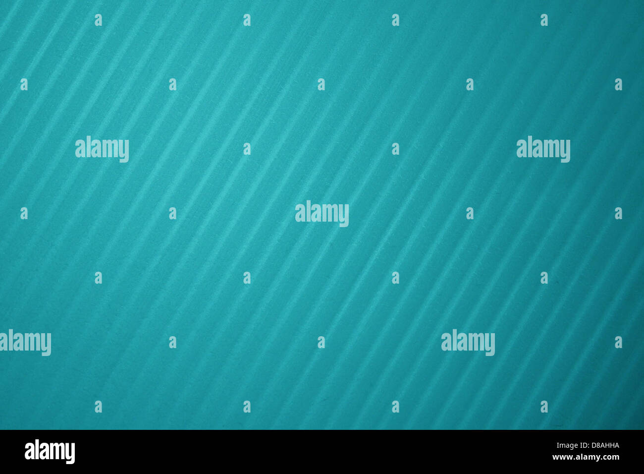 A close-up image of a teal-colored plastic surface with diagonal ...