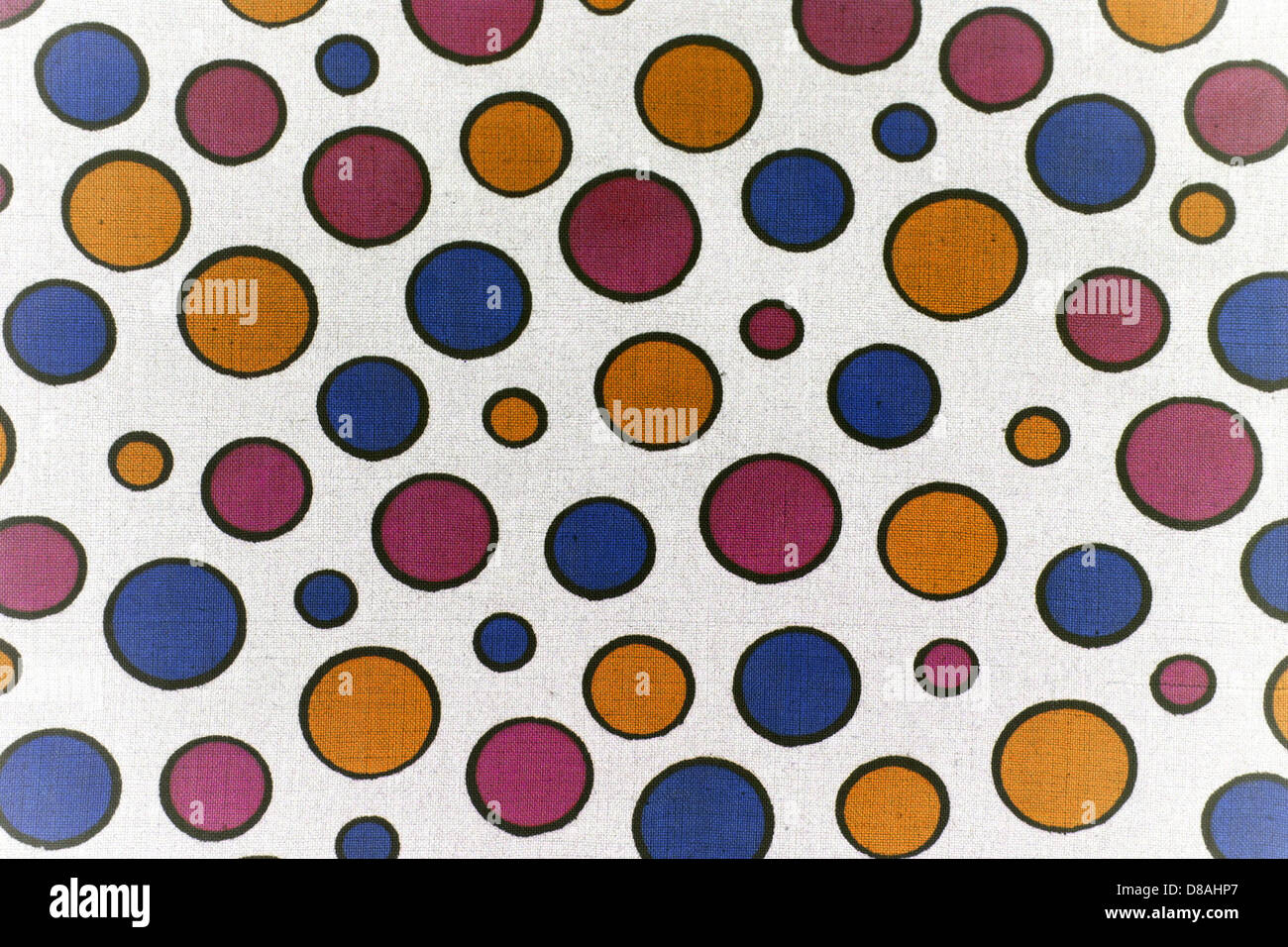 A close-up view of white fabric with a textured pattern of blue, pink, and orange dots. The ...