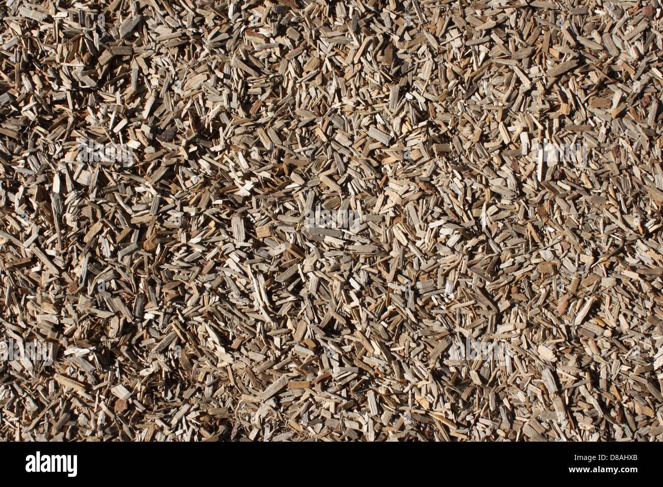 This image features a close-up of wood chips, showcasing their rough ...