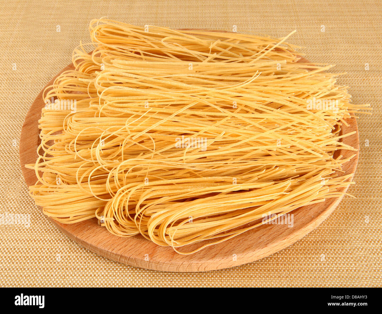 Raw italian pasta on wooden tray Stock Photo - Alamy