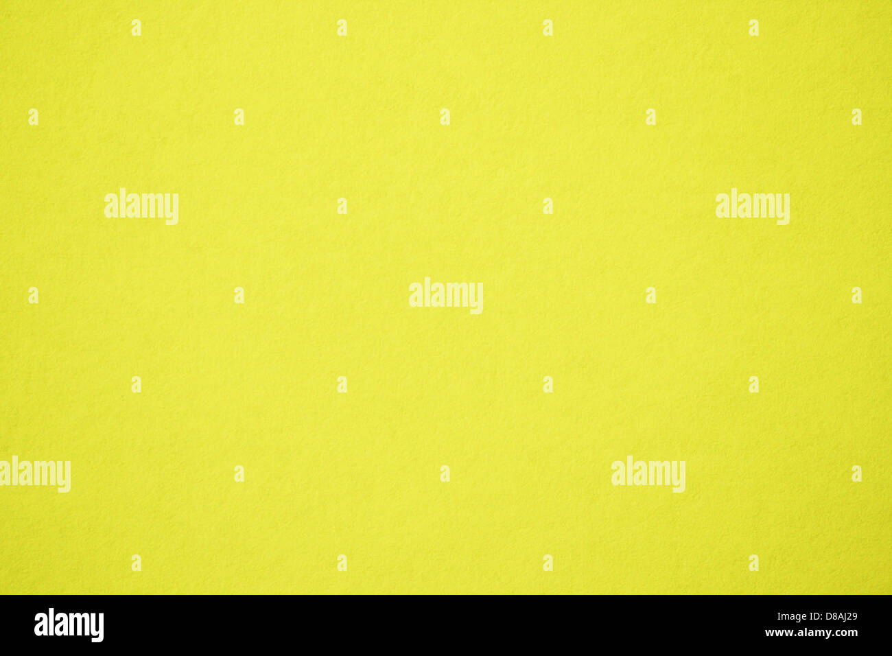 A textured close-up of yellow paper, showcasing its smooth surface with ...
