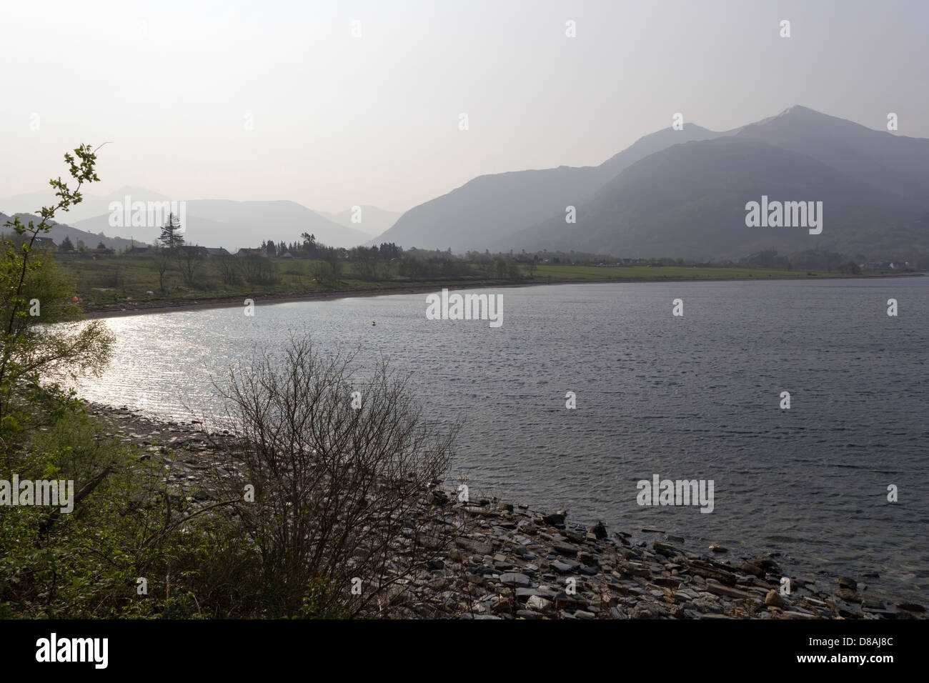 A lake in Scotland along with the greenery and hills on the shore ...
